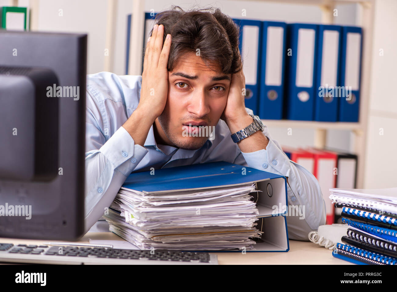 Overloaded busy employee with too much work and paperwork Stock Photo ...