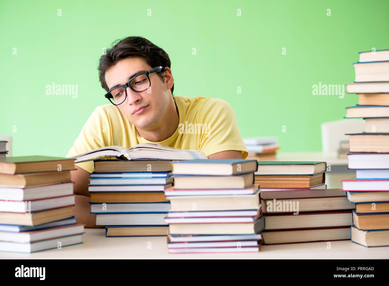 Student with too many books to read before exam Stock Photo - Alamy