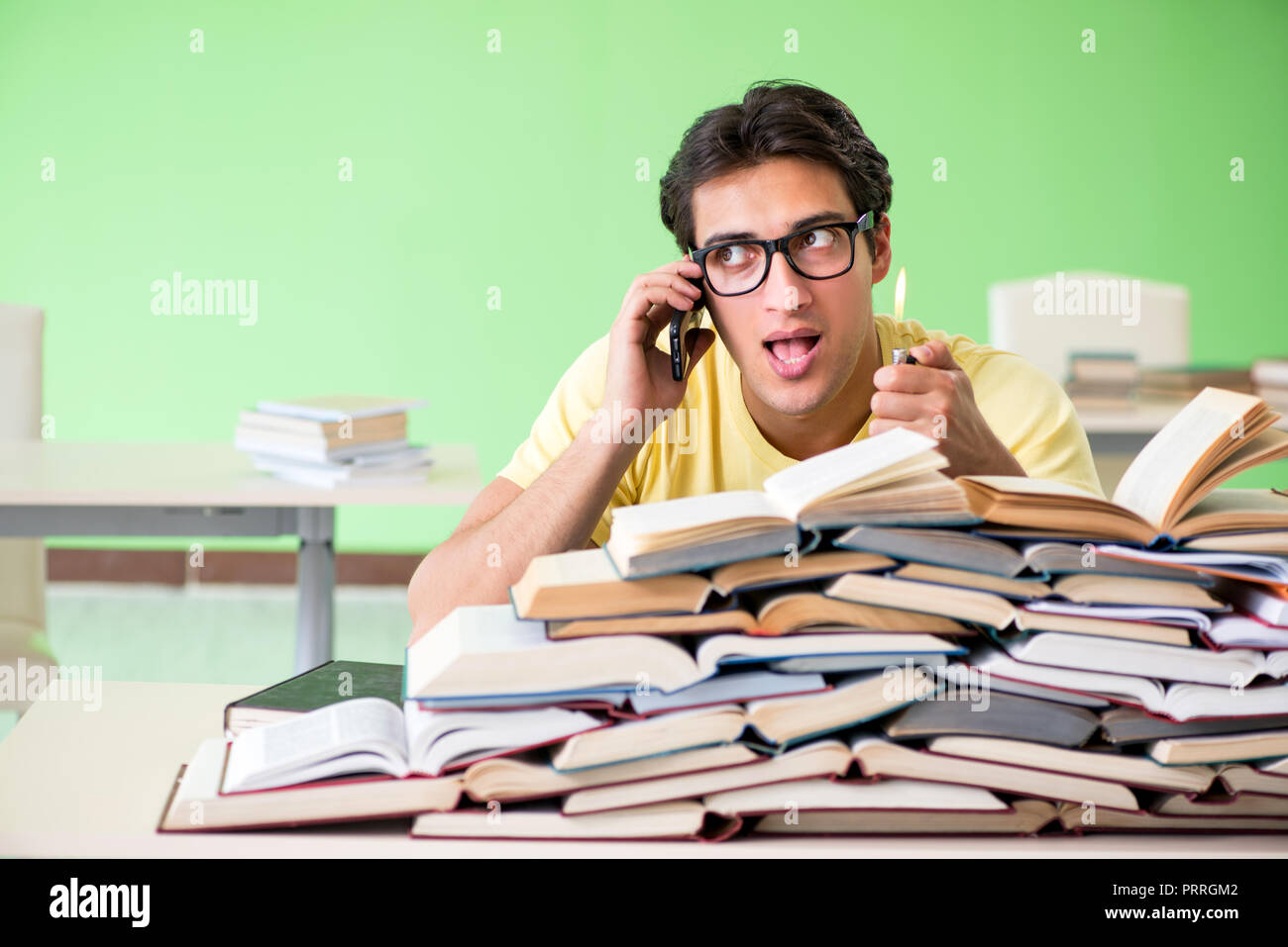 Student with too many books to read before exam Stock Photo - Alamy