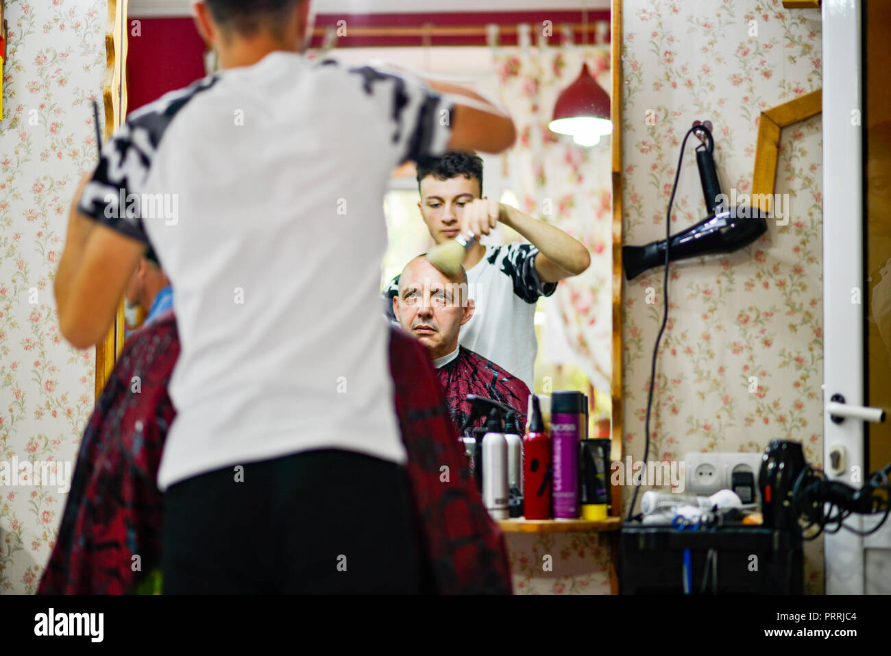 A visit to the barbershop for a close back and sides Stock Photo - Alamy