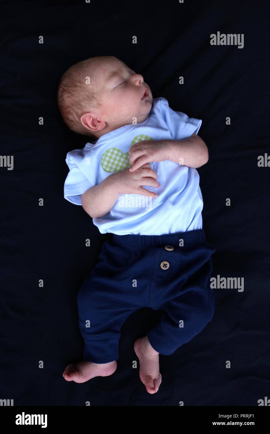 Sleeping baby seen from above against a black background Stock Photo ...