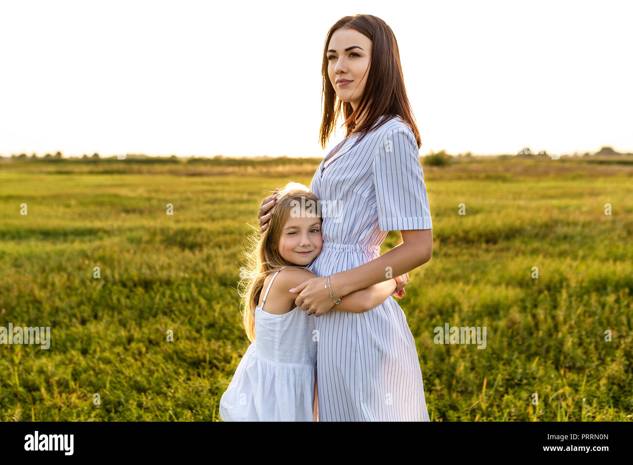Happy family in field sunset hi-res stock photography and images - Alamy