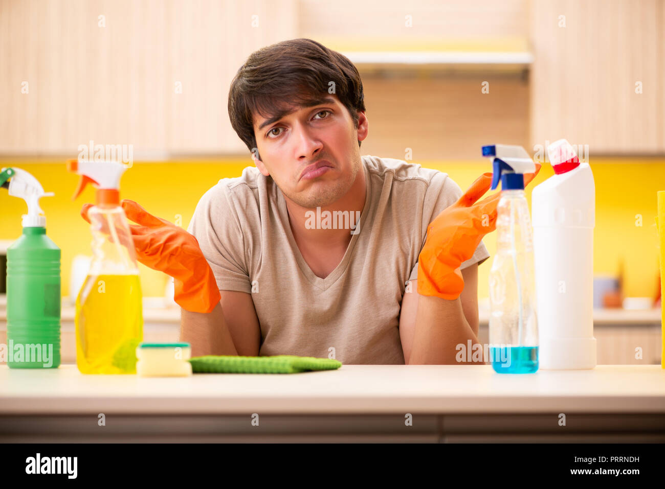 Single man cleaning kitchen at home Stock Photo - Alamy