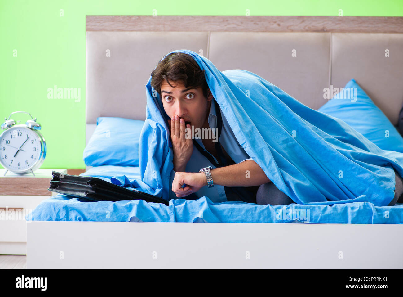 Employee in the bedroom being late for his job in time management ...