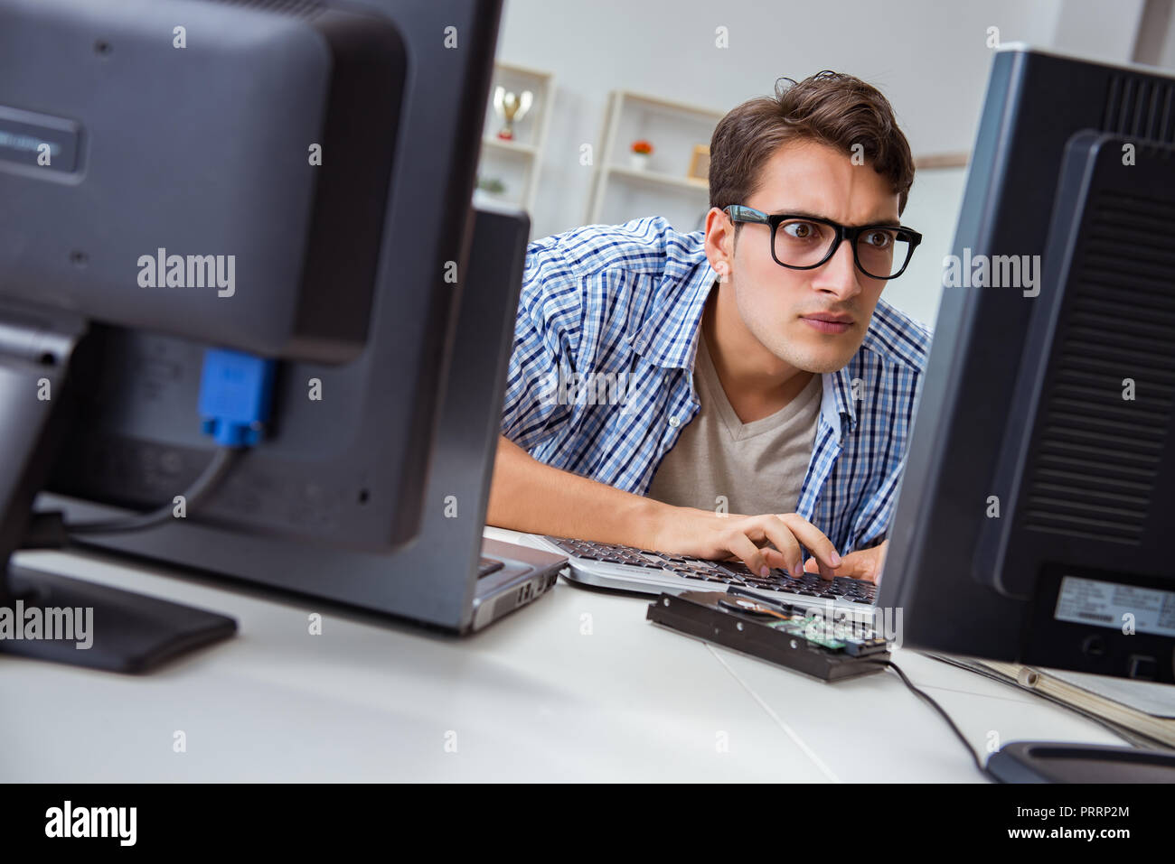 Young trader monitoring markets on screens Stock Photo - Alamy