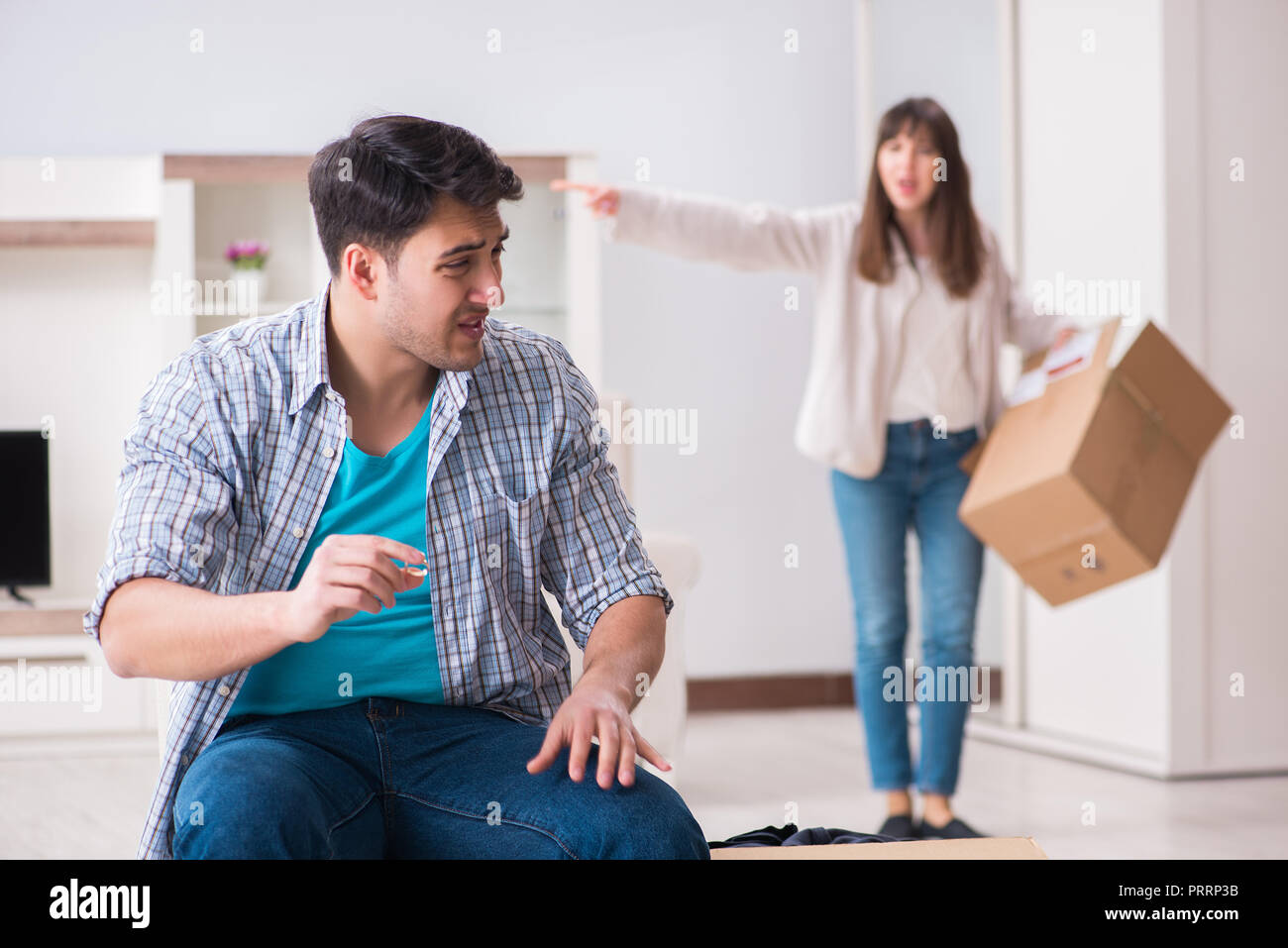 Woman evicting man from house during family conflict Stock Photo - Alamy