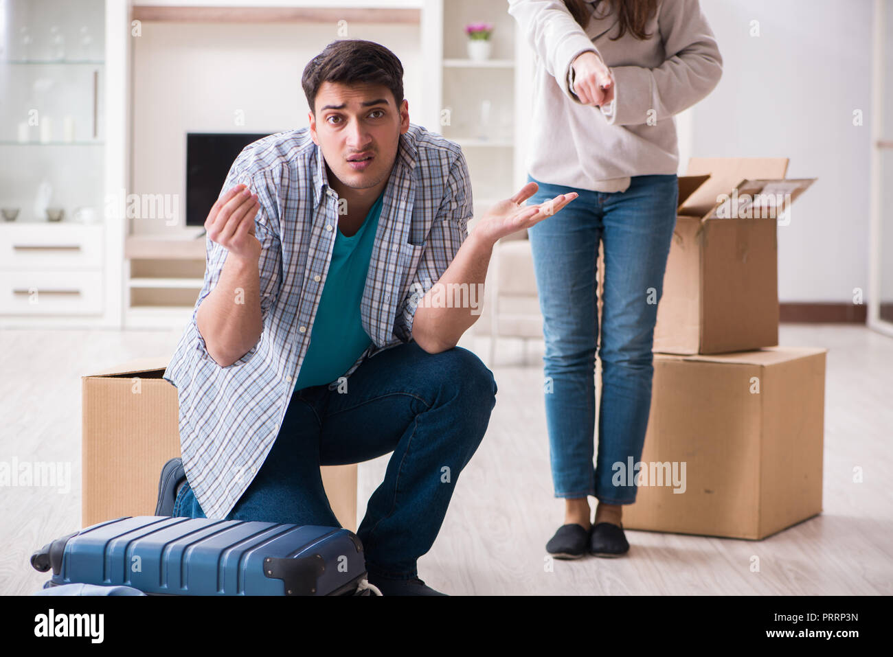 Woman evicting man from house during family conflict Stock Photo - Alamy