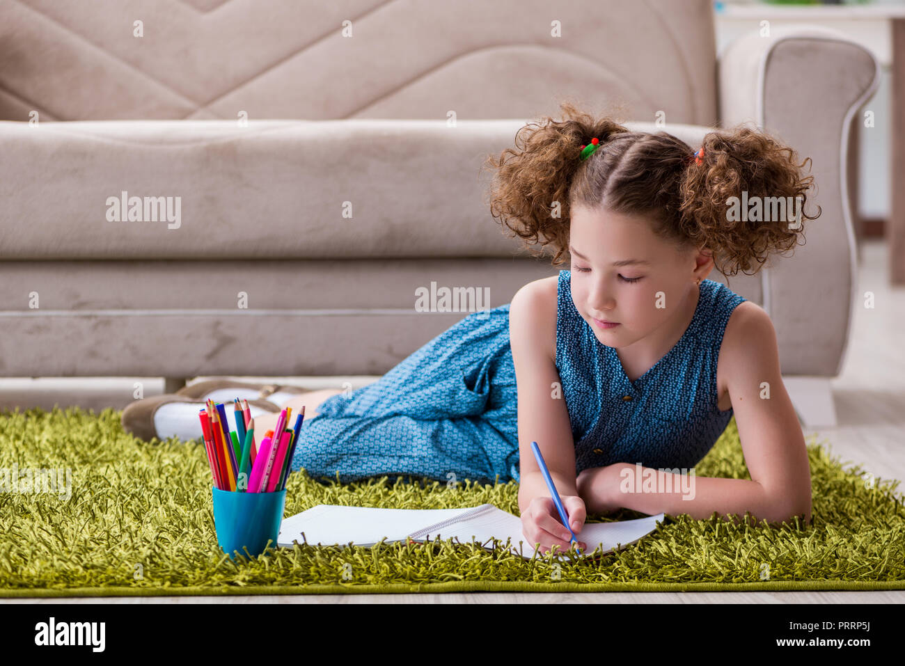 Young little girl drawing on paper with pencils Stock Photo - Alamy