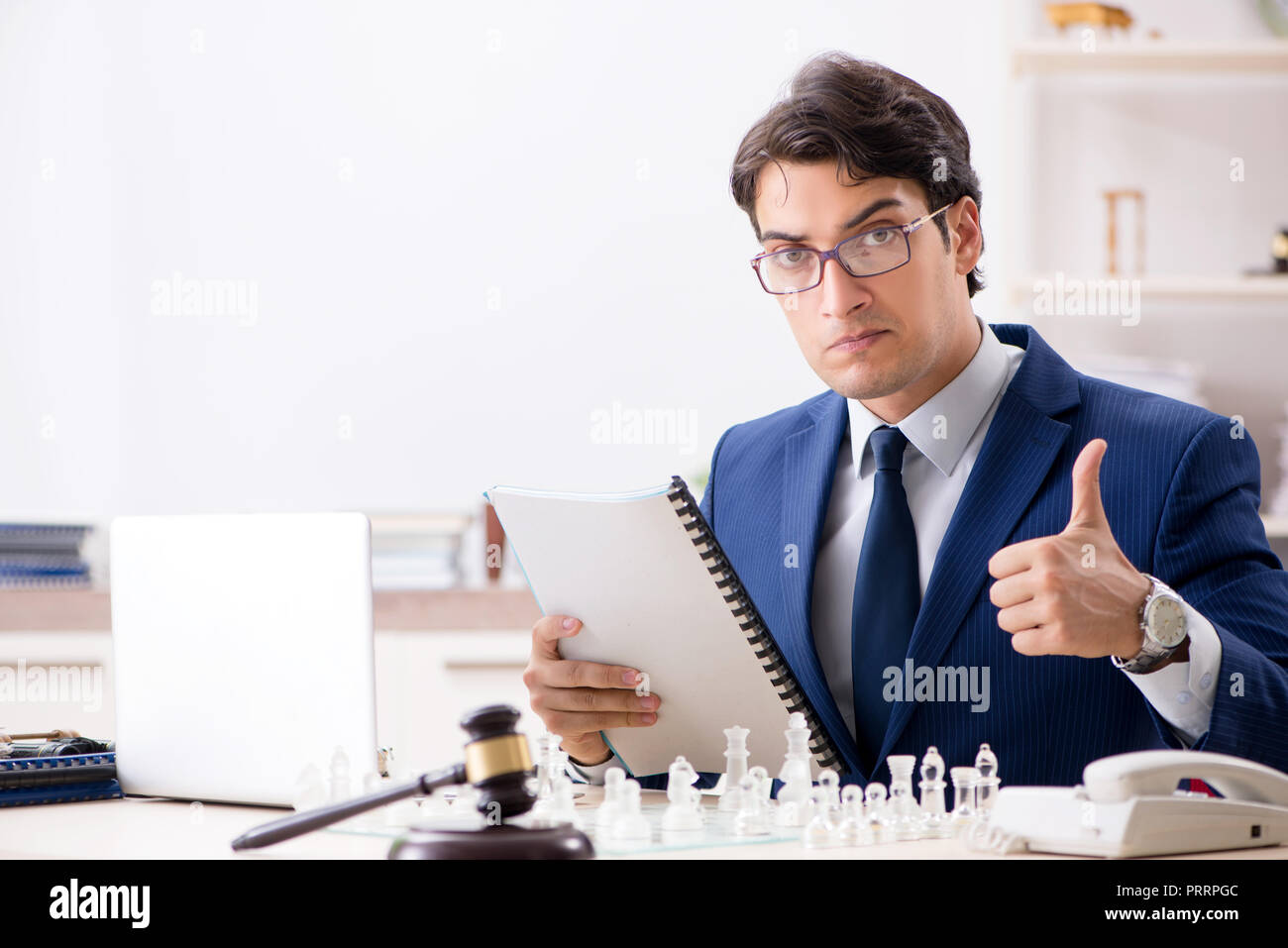 Young lawyer playing chess to train his court strategy and tactics ...