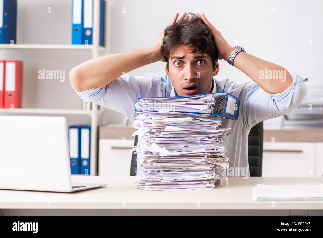 Overloaded busy employee with too much work and paperwork Stock Photo ...