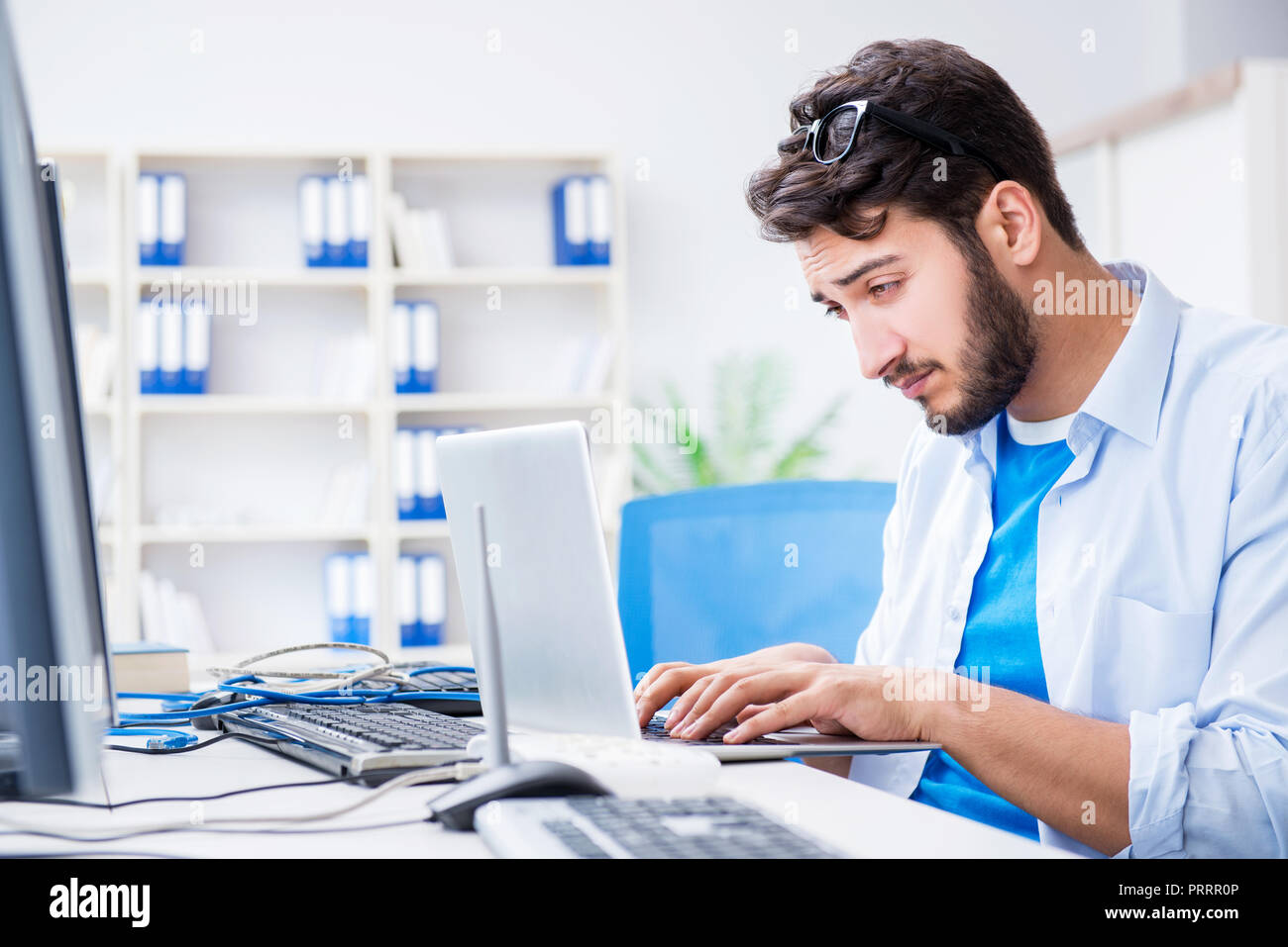IT technician looking at IT equipment Stock Photo - Alamy