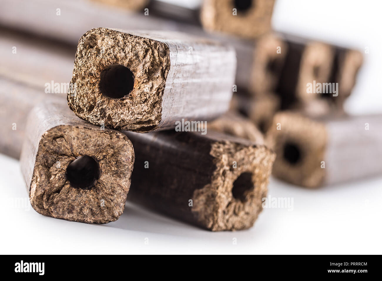 Wooden pressed briquettes Pini Kay from biomass on a white isolated ...