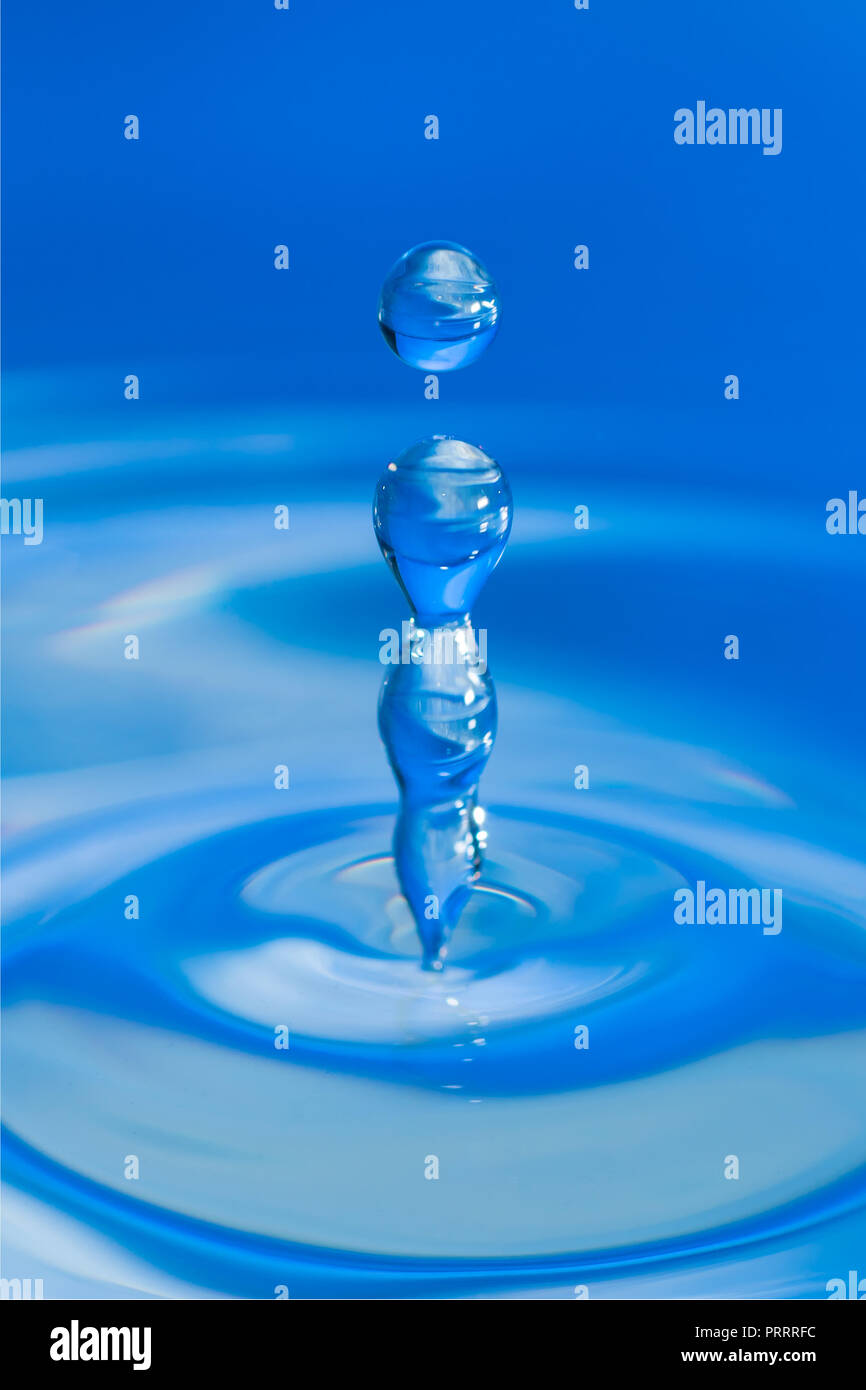 Colorful water droplet bouncing on water Stock Photo - Alamy