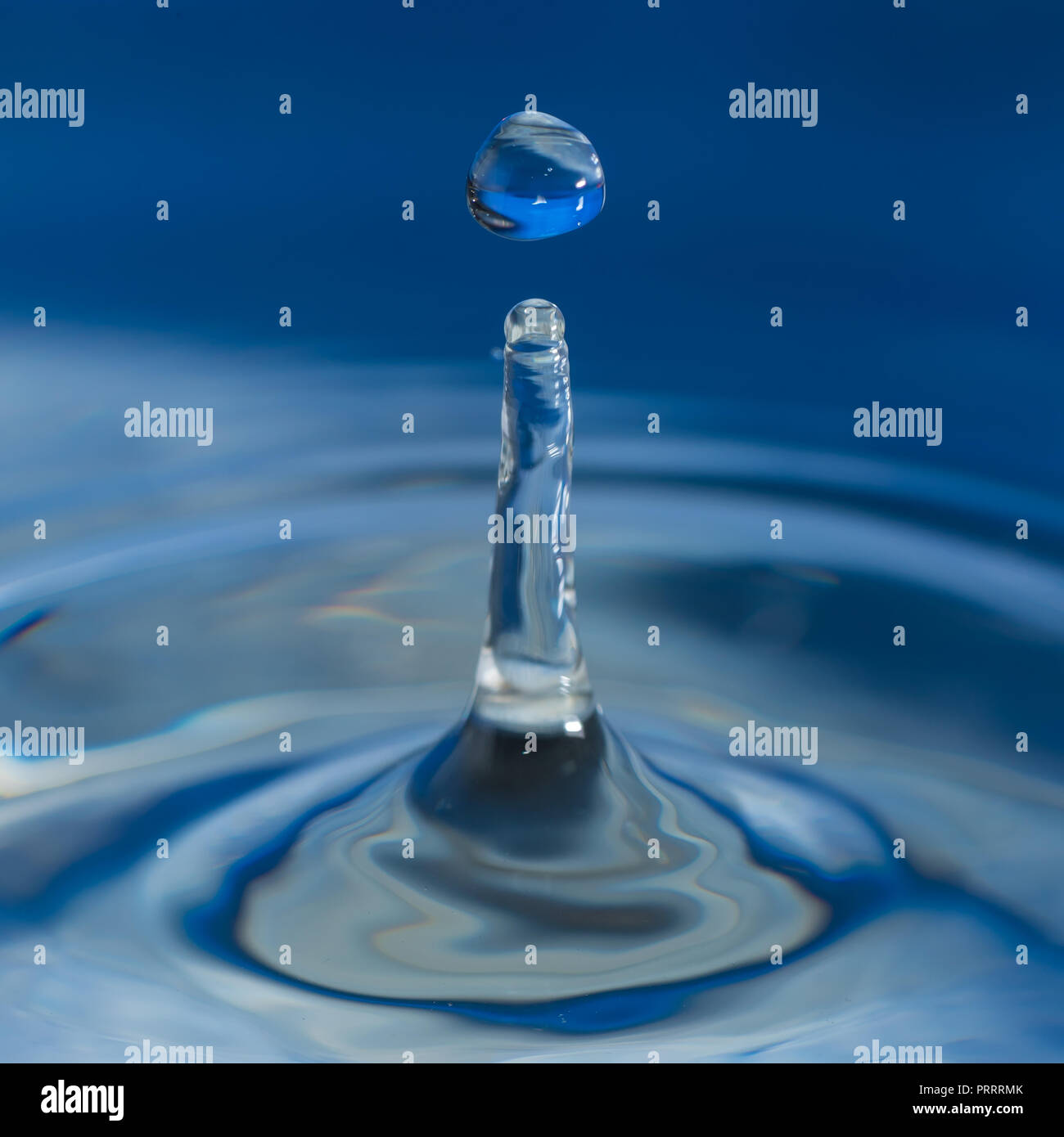 Colorful water droplet bouncing on water Stock Photo - Alamy