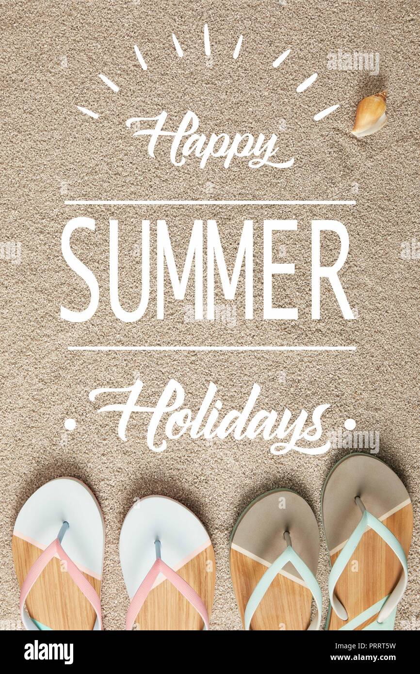 flat lay with summer flip flops and seashell on sand with "Happy summer ...