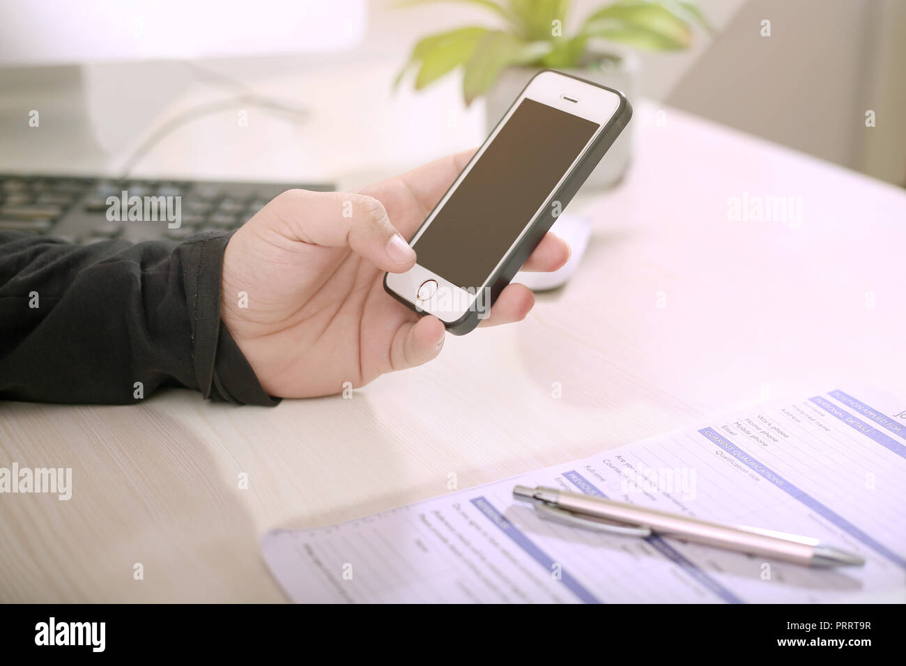 Man is holding phone in one hand Stock Photo - Alamy