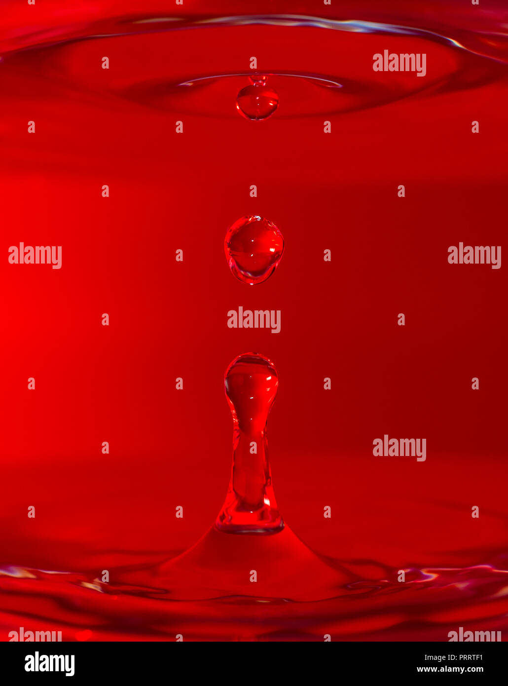 Colorful water droplet bouncing on water Stock Photo - Alamy