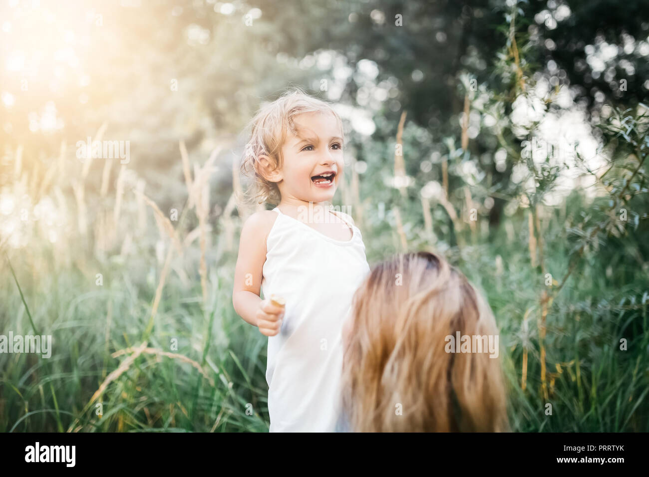 Mother daughter smiling grass hi-res stock photography and images - Alamy