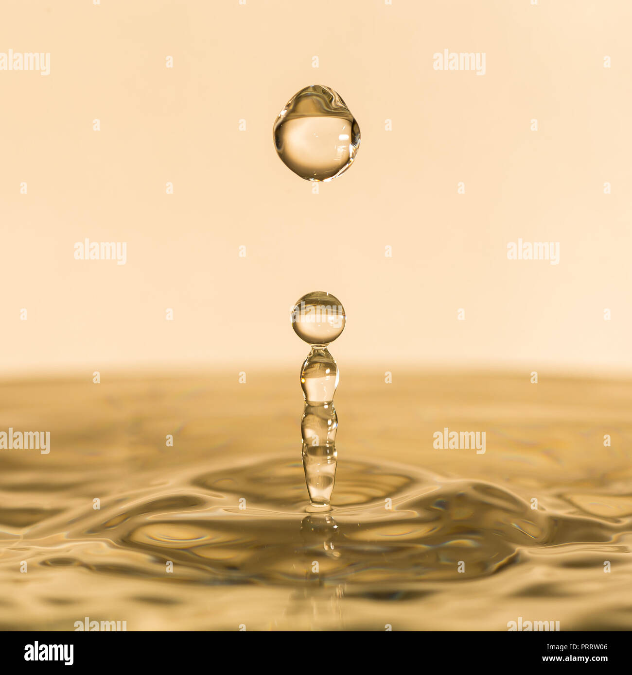 Colorful water droplet bouncing on water Stock Photo - Alamy