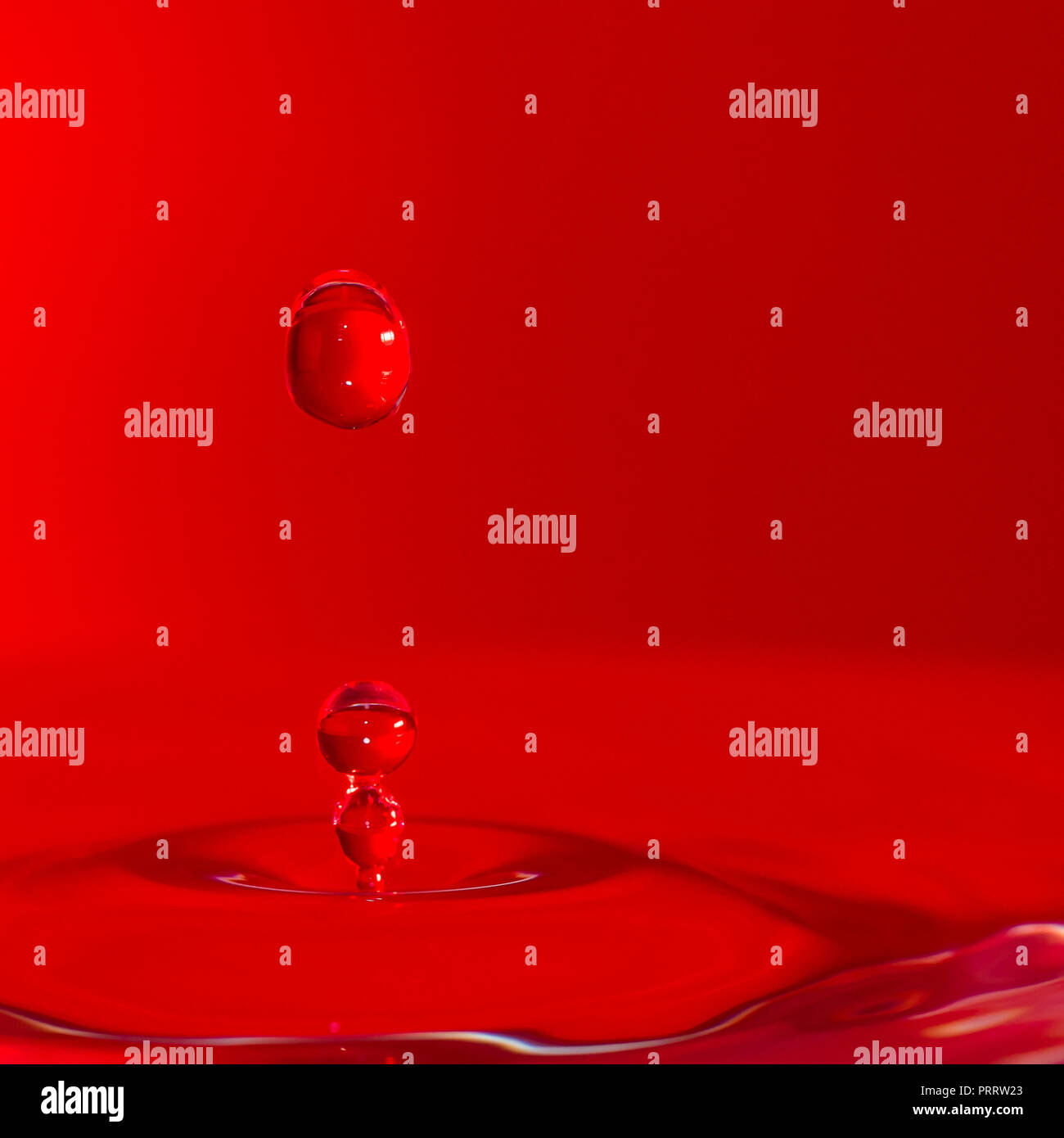 Colorful water droplet bouncing on water Stock Photo - Alamy
