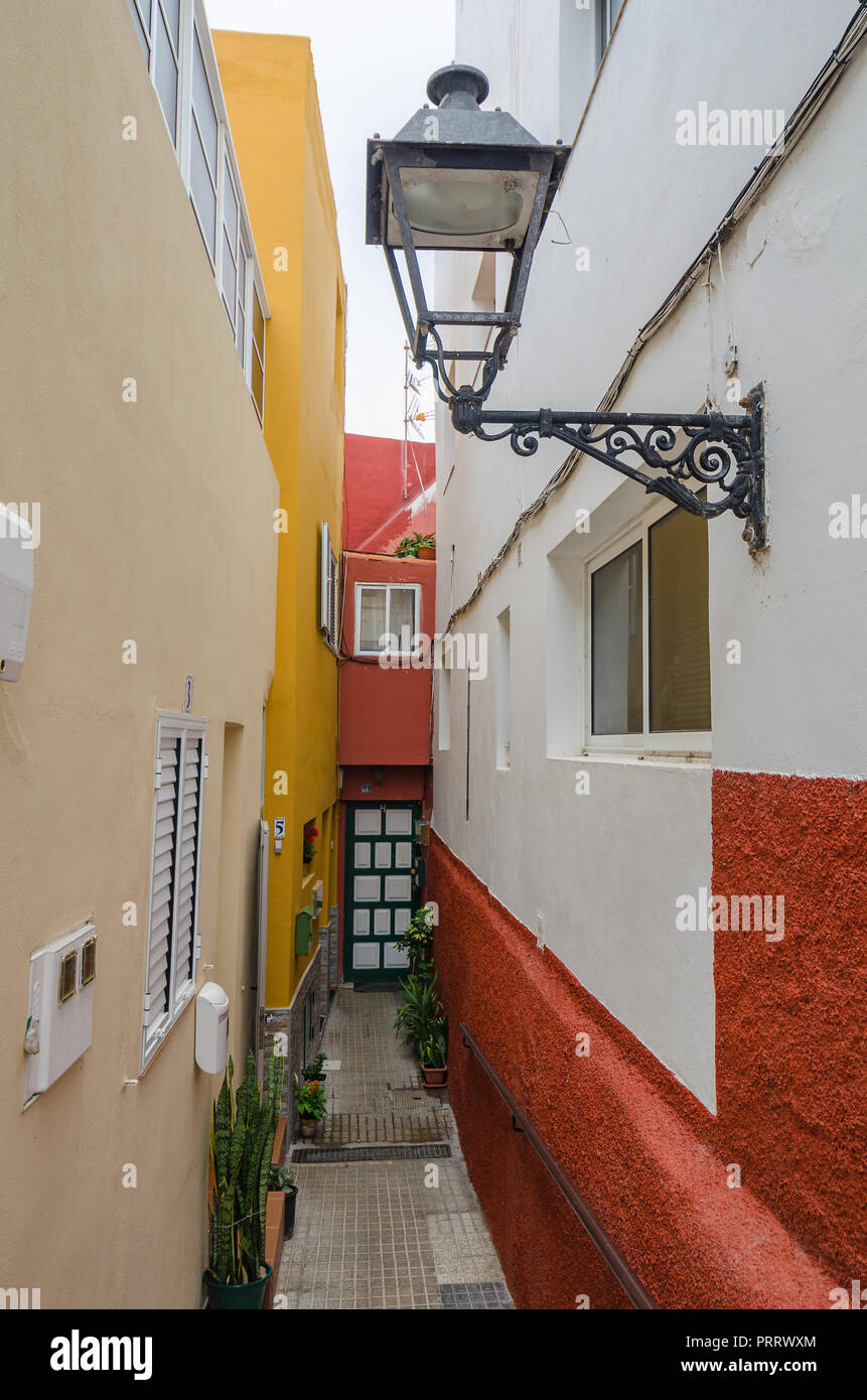 a narrow alley without people with coloured facades Stock Photo - Alamy