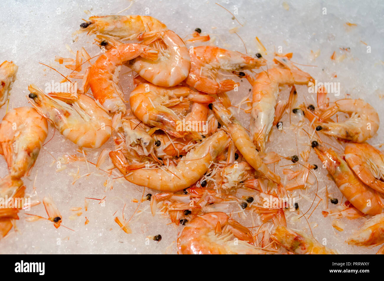 some raw red prawns on crushed ice Stock Photo - Alamy