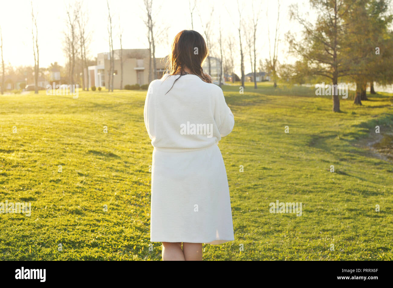 Woman wearing bathrobe walking outdoors at sunset Stock Photo - Alamy
