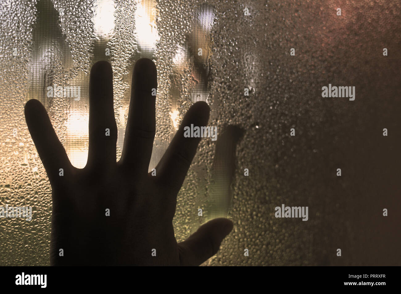 Hand on condensed window in the dark Stock Photo - Alamy