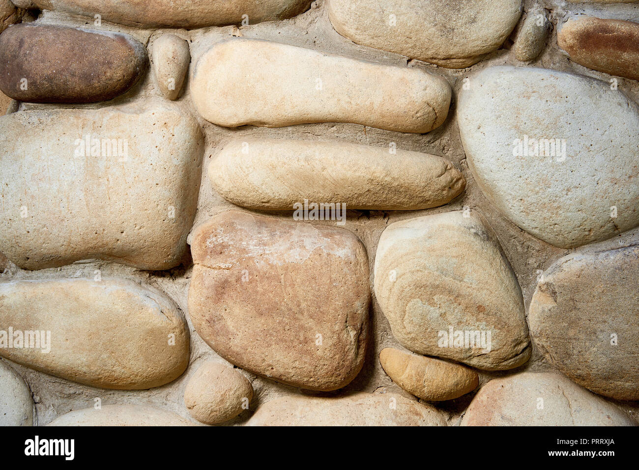 close-up view of rough weathered stone wall texture, full frame ...