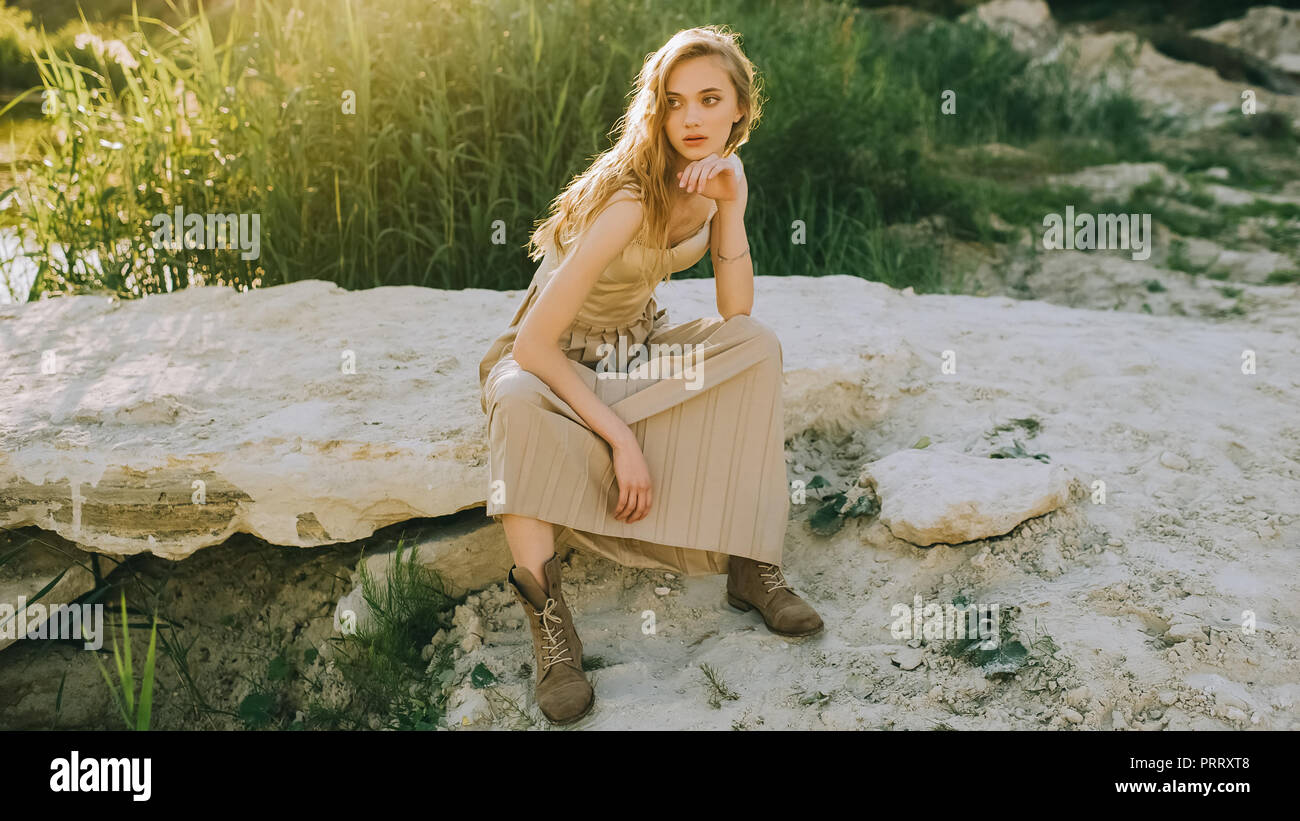 Girl sitting on ground hi-res stock photography and images - Alamy
