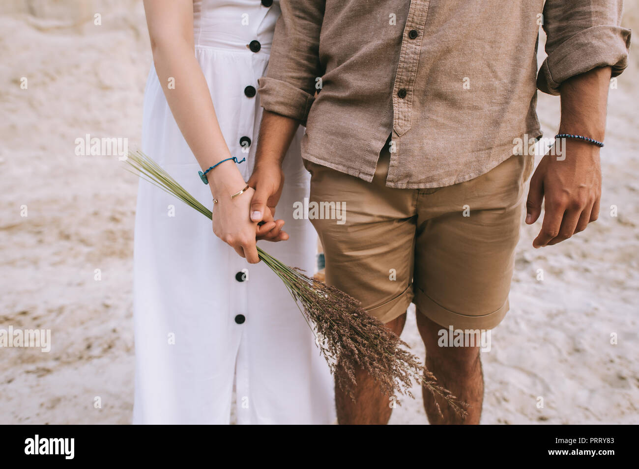 cropped view of stylish couple holding hands Stock Photo - Alamy