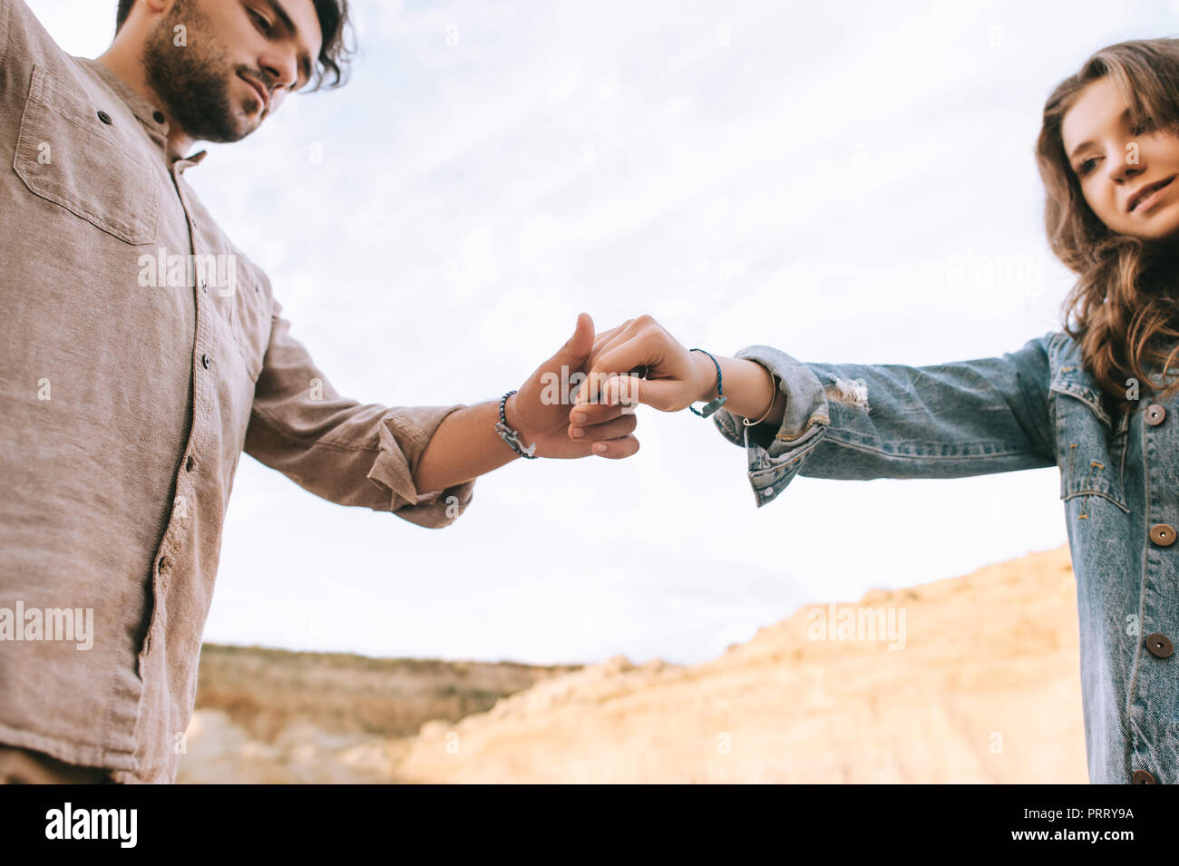 young stylish couple holding hands together Stock Photo - Alamy