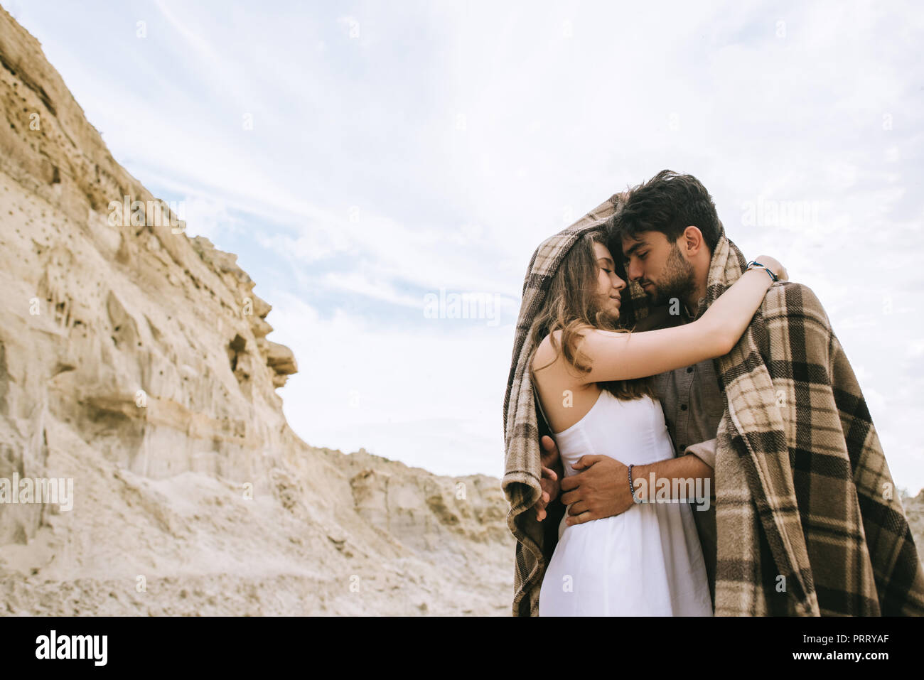 Couple hugging under blanket hi-res stock photography and images - Alamy