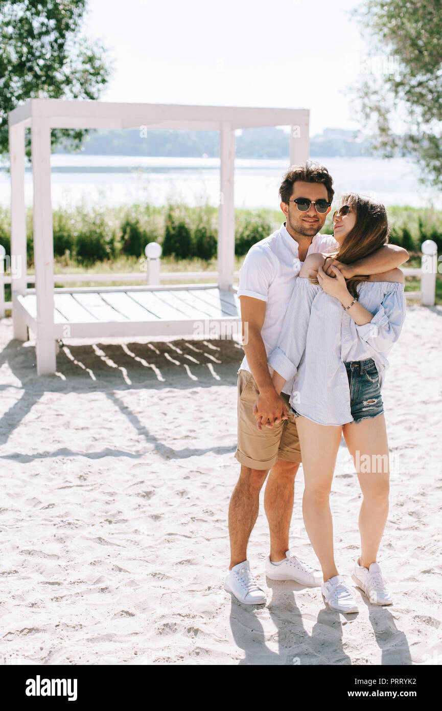 happy boyfriend hugging girlfriend at sandy city beach Stock Photo - Alamy