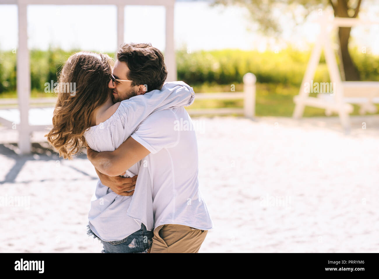 couple hugging at sandy city beach in summer Stock Photo - Alamy