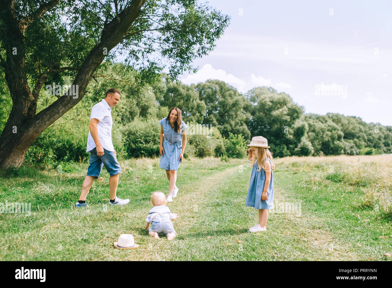 happy family with two kids spending time together on summer feild Stock ...