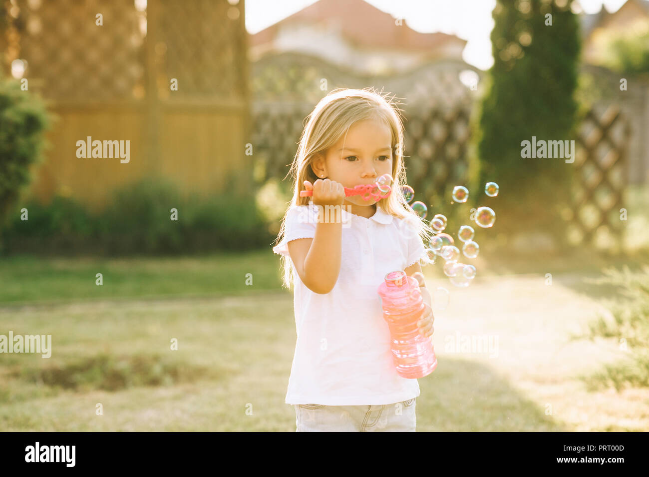 portrait of cute little kid blowing soap bubbles on yard on summer day ... portrait of cute little kid blowing soap bubbles on yard on summer day ...