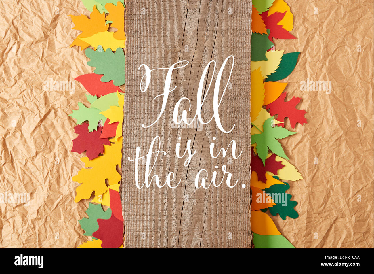 top view of wooden plank with "fall is in the air" inspiration and ...