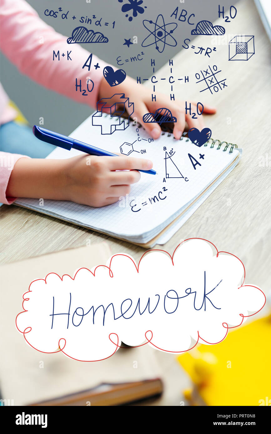cropped shot of schoolchild taking notes while studying with books and ...