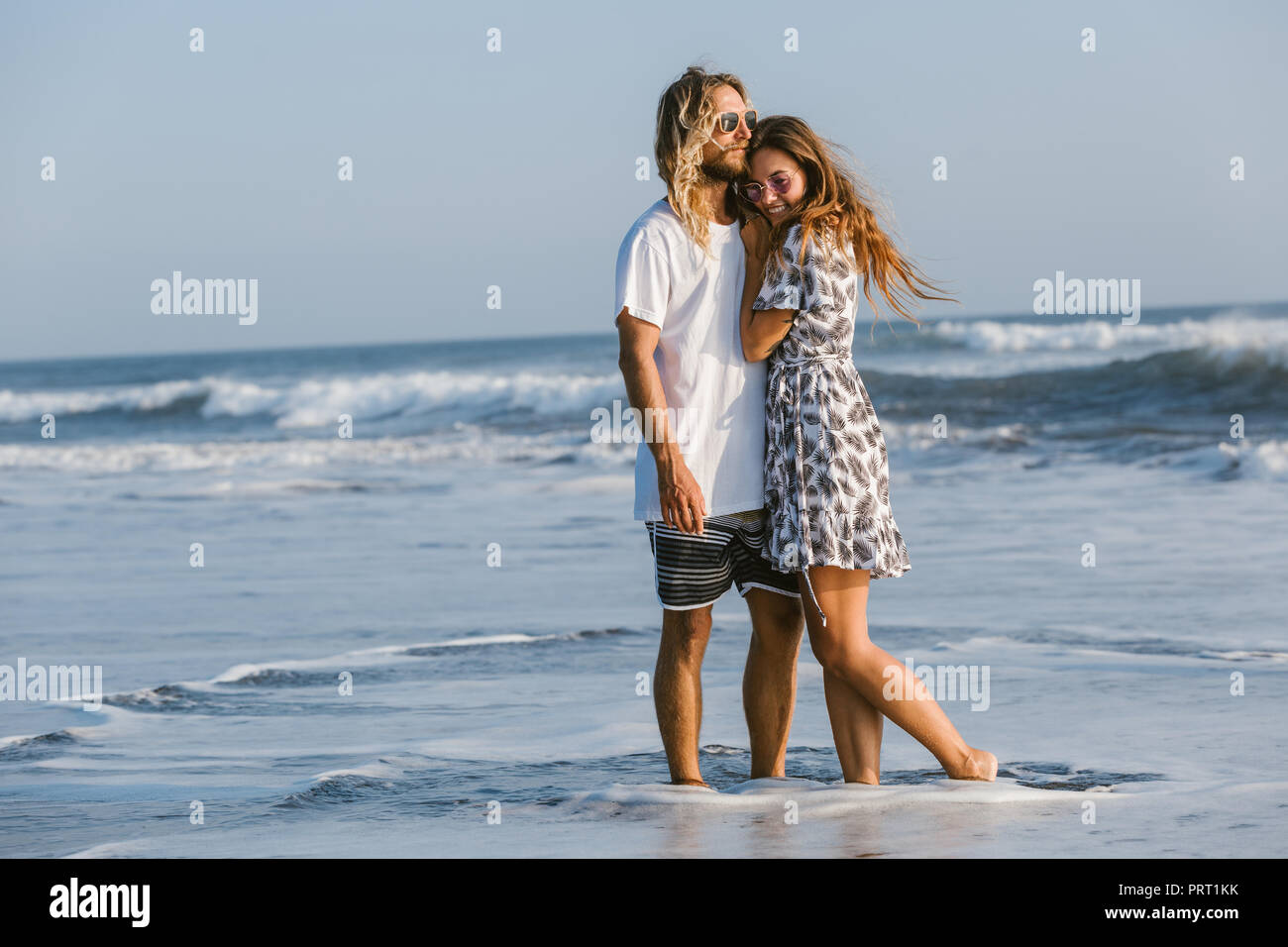 couple cuddling on ocean beach in bali, indonesia Stock Photo - Alamy