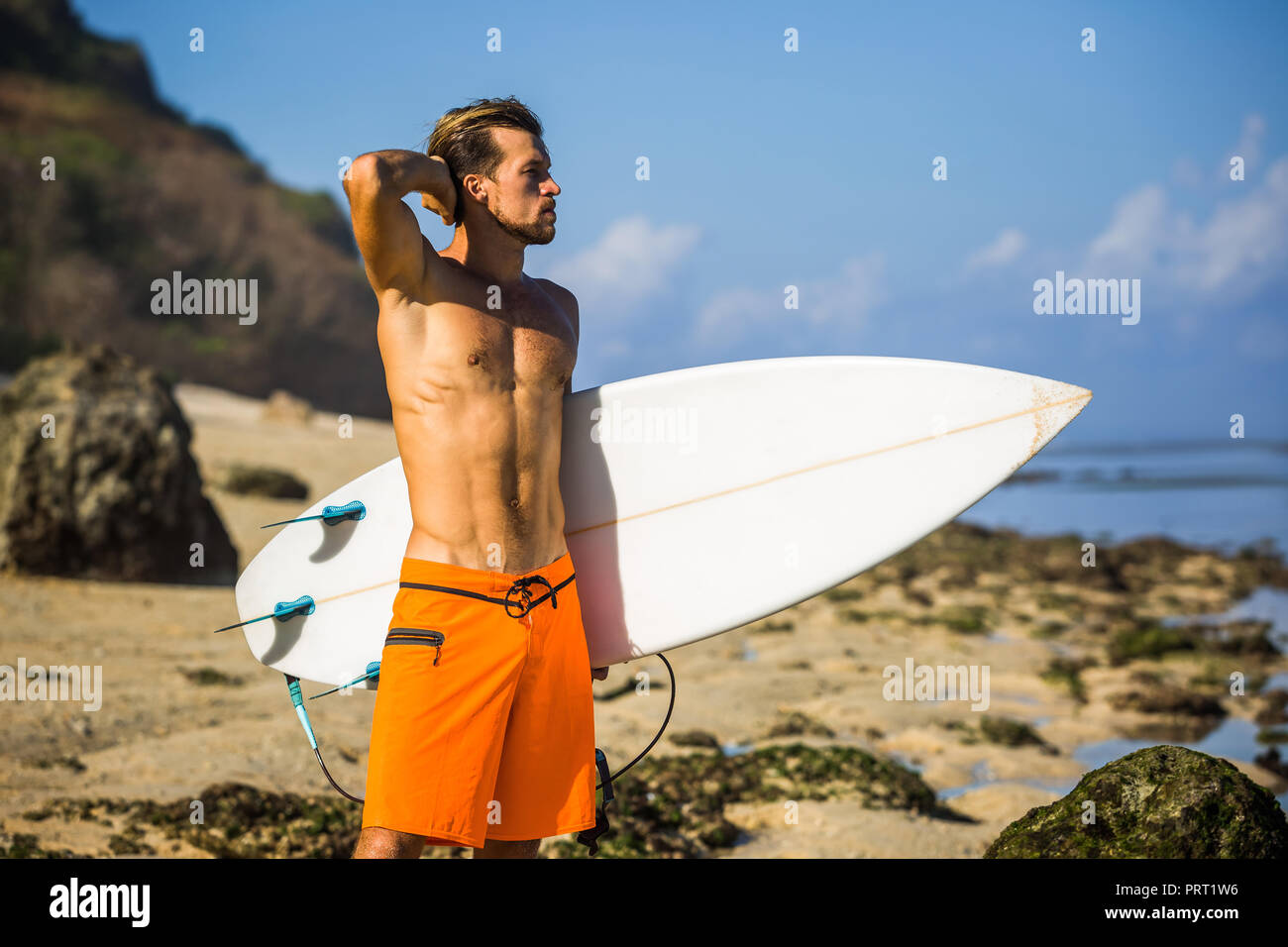Handsome man standing surfing board hi-res stock photography and images ...