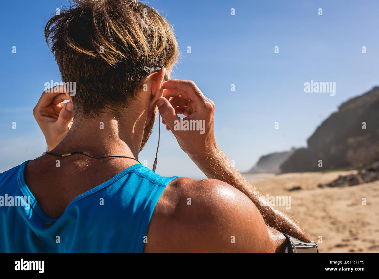 back view of man listening music with earphones Stock Photo - Alamy