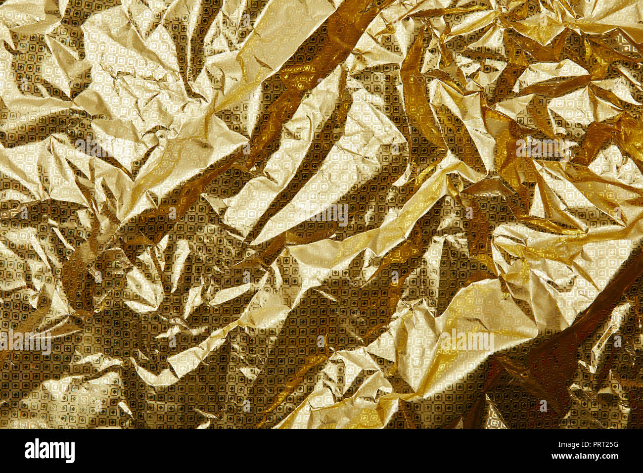 full frame of shiny crumpled golden wrapping paper as background Stock ...