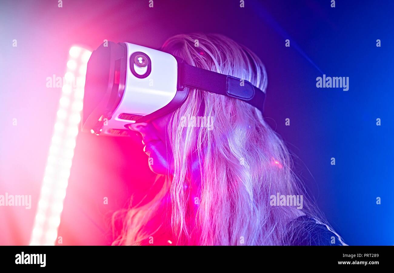 Young woman wearing VR headset Stock Photo - Alamy