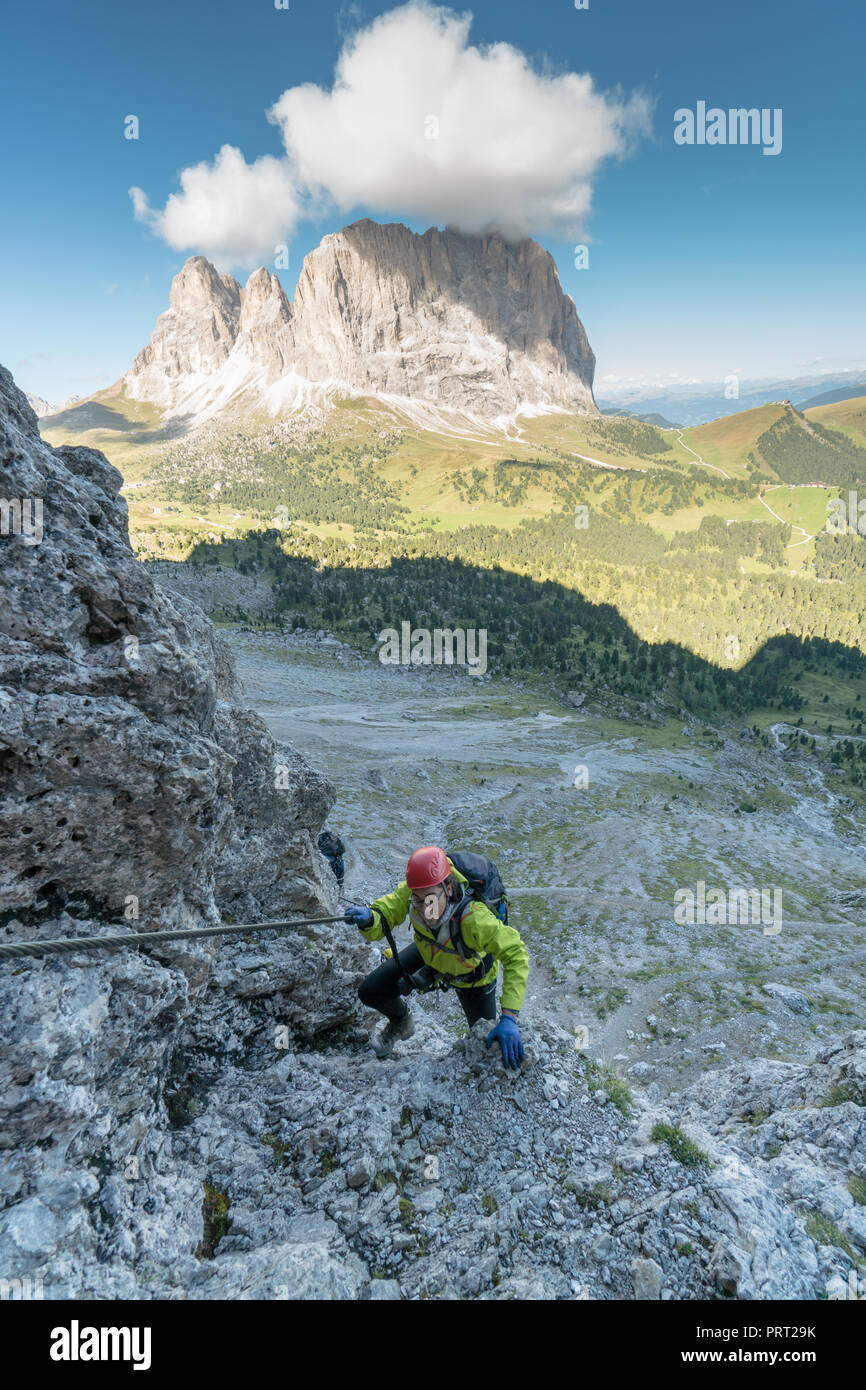 young attractive female mountain climber in the Dolomites of Italy with ...