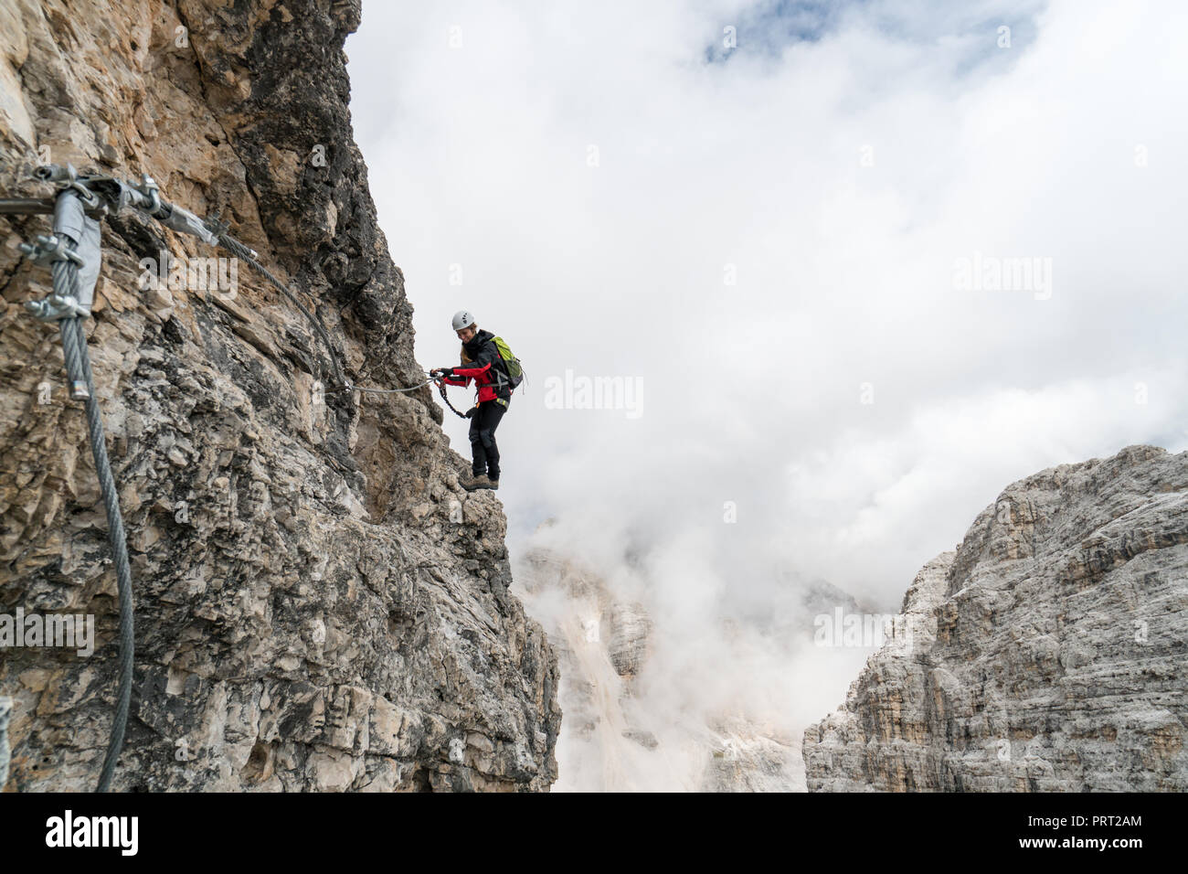 young attractive female university student on a vertical and exposed ...