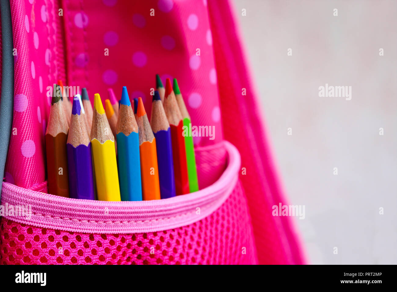 colored pencils in backpack Stock Photo - Alamy