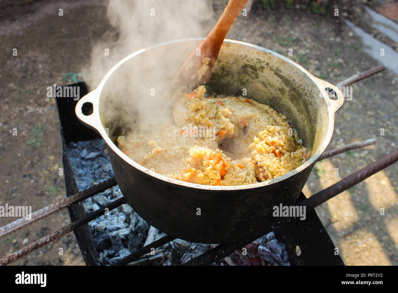 Pilaf cooking on a fire Stock Photo - Alamy