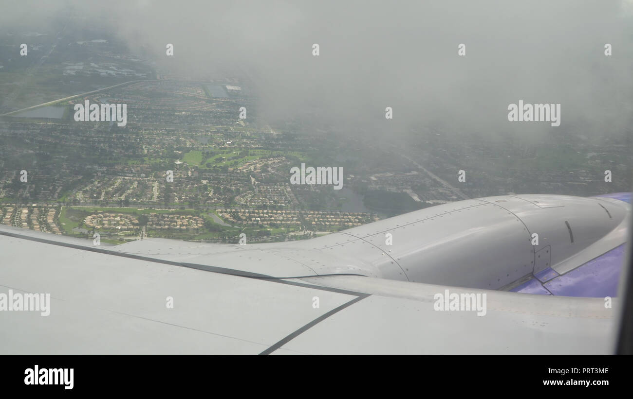 View outside commercial airplane window looking over wing and engine to ...