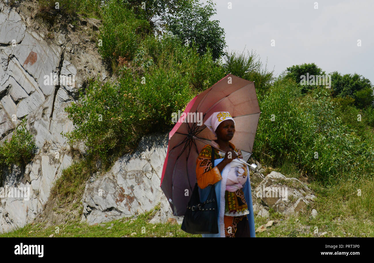 A Rwandan woman walking on the road in rural Rwanda Stock Photo - Alamy